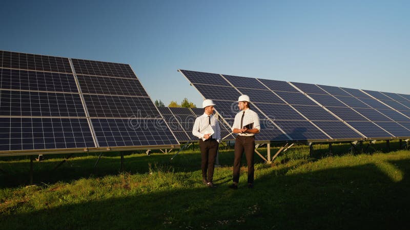 Engineers Walk through Solar Panel Station Discussing Progress Stock ...