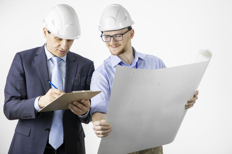 Engineers Working with Blueprint Marking Edits in Documents on ...