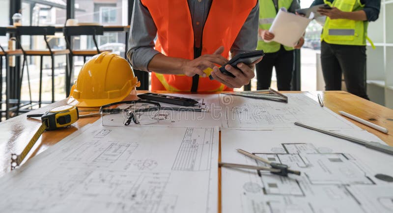 Engineers Working on Blueprints and Construction Plans. Building ...