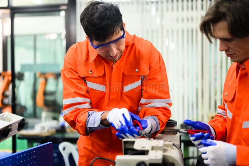 Engineers Working and Solving Problems on Machine at Industrial Plant ... Engineers Working and Solving Problems on Machine at Industrial Plant ...