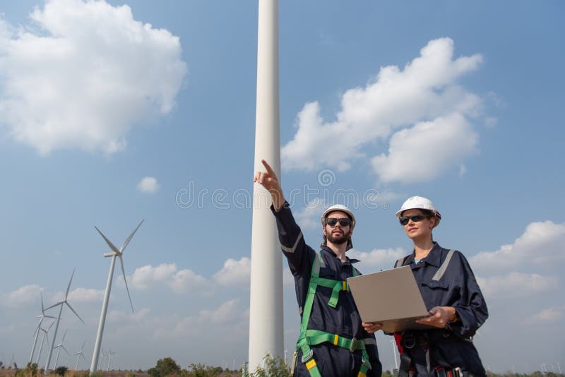 Engineers Working and Using a Computer Laptop on Site in Wind Turbine ...