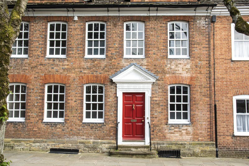 English House with Red Bricks, White Windows and Red Door, England ...