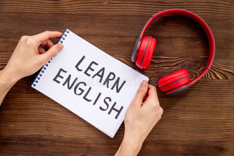 English Lessons Concept. Headpones with Notebook on Student Table Desk ...