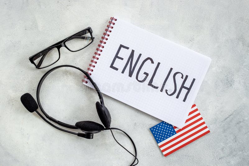 English Lessons Concept. Headpones with Notebook on Student Table Desk ...