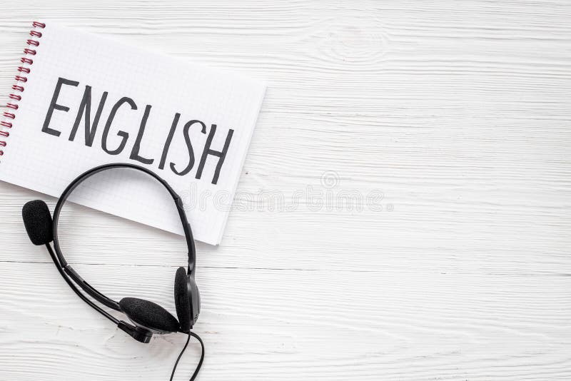 English Lessons Concept. Headpones with Notebook on Student Table Desk ...