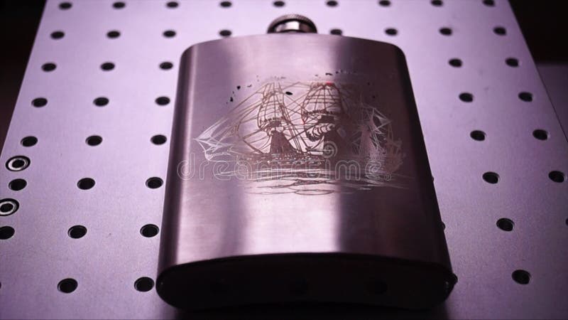 Engraved Metal Flask with Ship Design on Industrial Background Stock ...