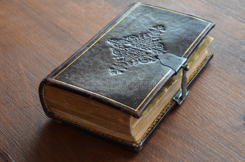 Engraved Old Book with Lock on Wood Table Stock Image - Image of ...
