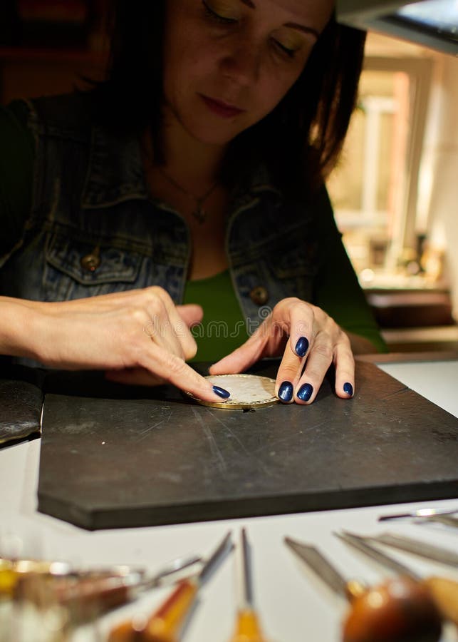 Woman engraver at work. stock image. Image of craftsman - 150812895