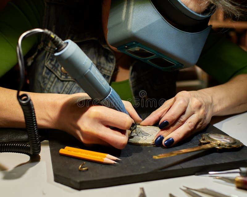 Woman engraver at work. stock photo. Image of design - 150815488