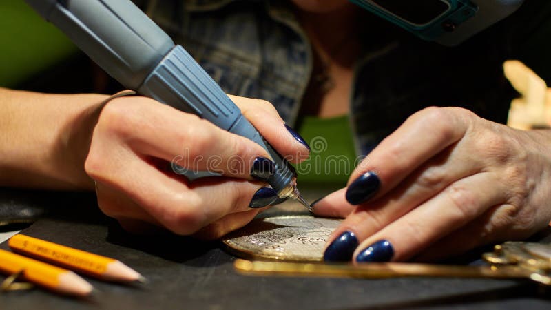 Woman engraver at work. stock photo. Image of closeup - 150817898