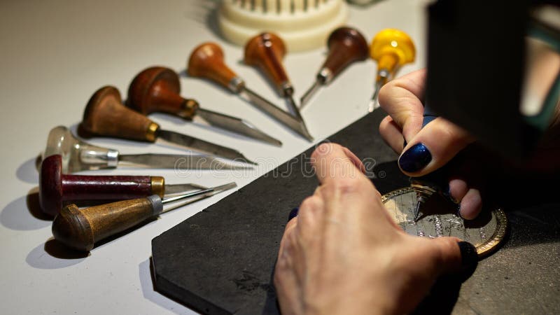 Woman engraver at work. stock photo. Image of engraving - 150811086