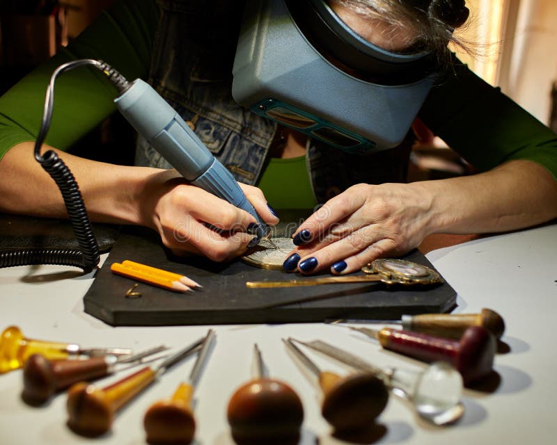 Woman engraver at work. stock photo. Image of engraver - 150821742