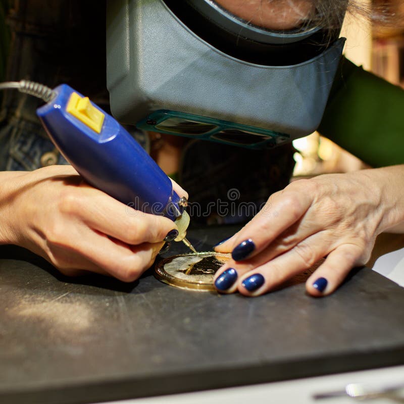 Woman engraver at work. stock image. Image of craft - 150822353