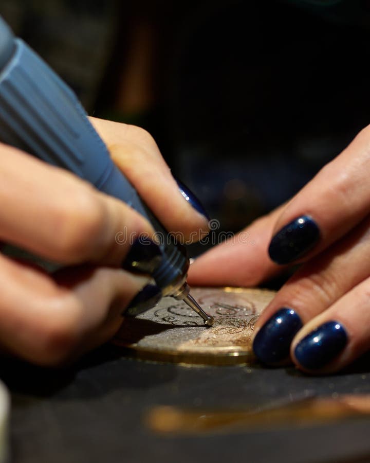 Woman engraver at work. stock image. Image of business - 150847237