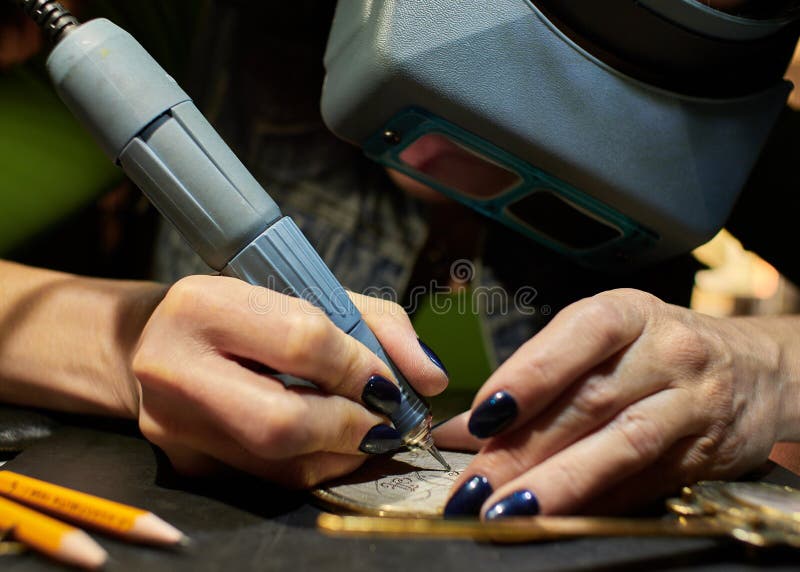Woman engraver at work. stock image. Image of business - 150894971