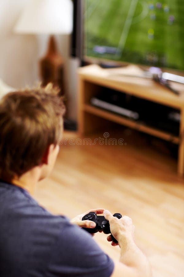 Engrossed in the Game. Handsome Guy Playing a Video Game Using a ...