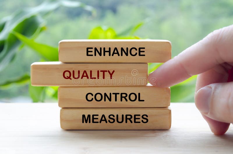 Enhance Quality Control Measures Text on Wooden Blocks Representing ...