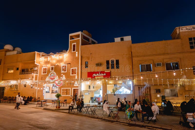 A Vibrant Night Photo of a Cafe Scene in the Samhania District of ...