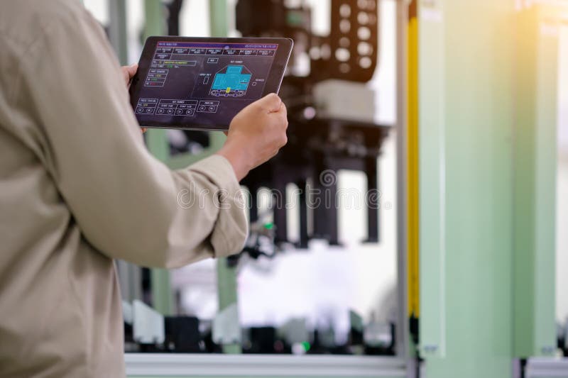 Enineer Use Computer Tablet Monitoring Work Process of Machine Stock ...