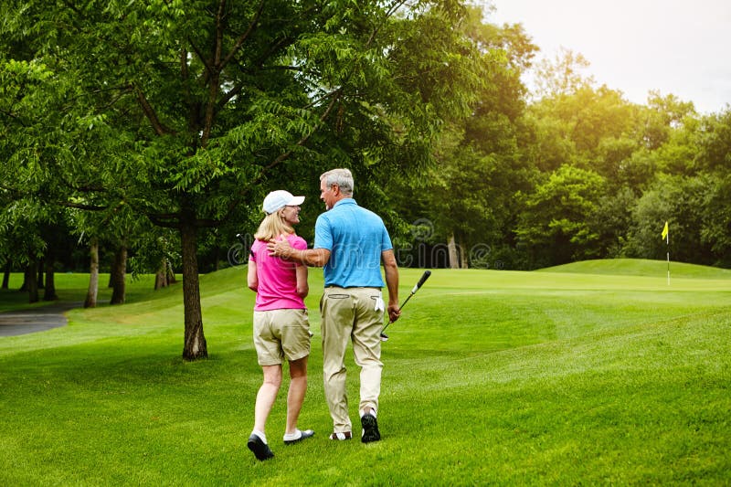 Lets Take a Romantic Walk Towards Our Course. a Mature Couple on a Golf ...