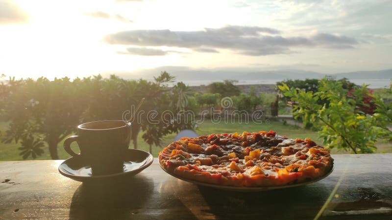 Enjoy a Quiet Afternoon with a Cup of Coffee and Pizza Stock Photo ...