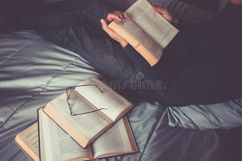 Enjoy reading book in bed. stock image. Image of holding - 93525633
