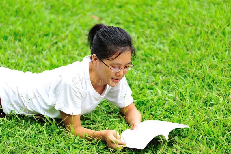 Reading on green grass stock image. Image of casual, land - 26746801