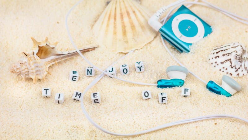 Enjoy Time Off Letters between Sea Shells and Audio Player on Sandy ...