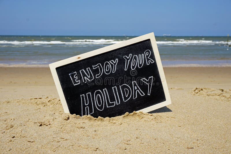 Enjoy your holiday written stock photo. Image of board - 280493012