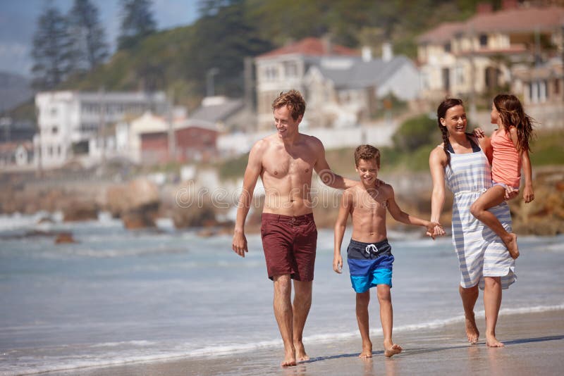 Enjoying the Beach Together. a Family Walking Along the Beach. Stock ...