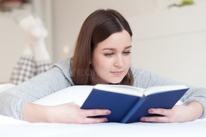 Enjoying a book stock image. Image of cute, morning, comfortable - 67212271
