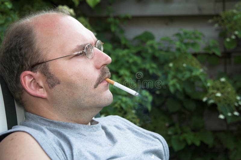 Enjoying a cigarette stock photo. Image of smoke, lungcancer - 1054848