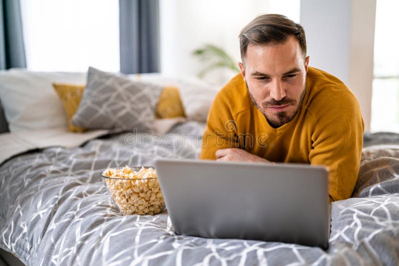 Enjoying His Leisure Time at Home. Handsome Young Man Using Computer ...