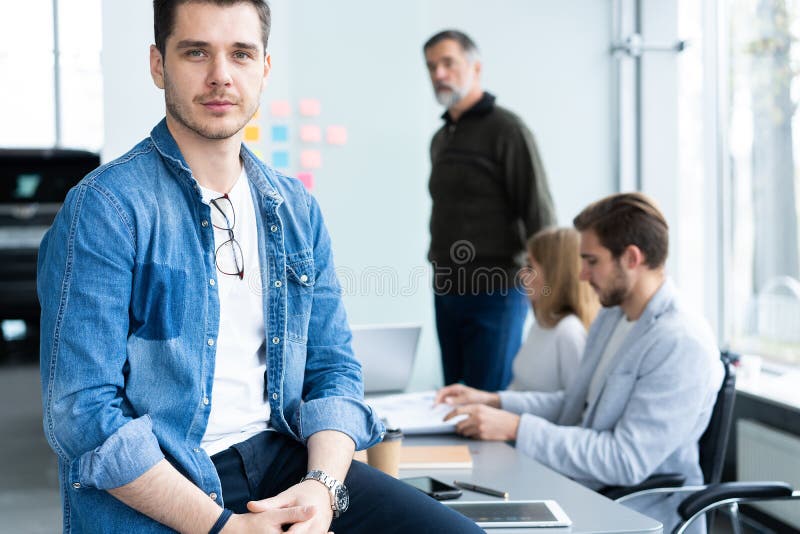 Enjoying His Work. Handsome Young Man Looking at Camera and Smiling ...