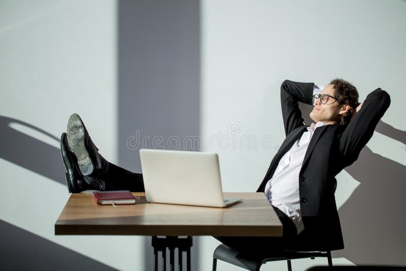 Man Keeping Legs on Table and Working on Laptop in Office Stock Photo ...