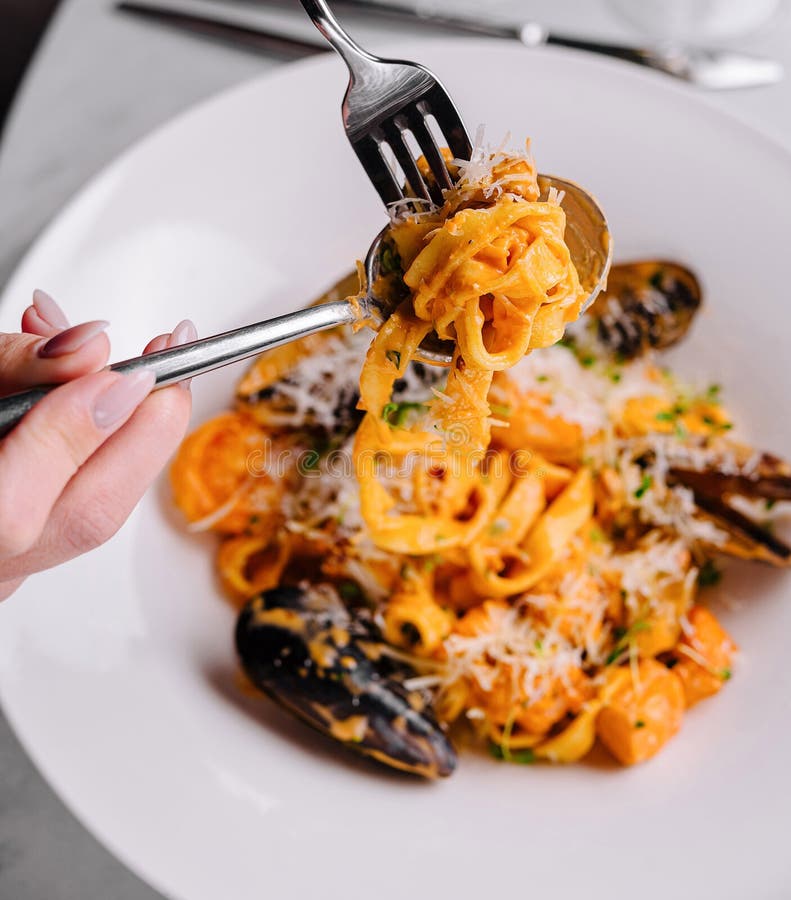 Enjoying Seafood Pasta at Elegant Dining Table Stock Photo - Image of ...
