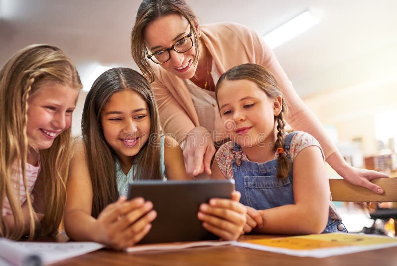 Enriching Young Minds the Modern Way. a Teacher Helping Her Students ...