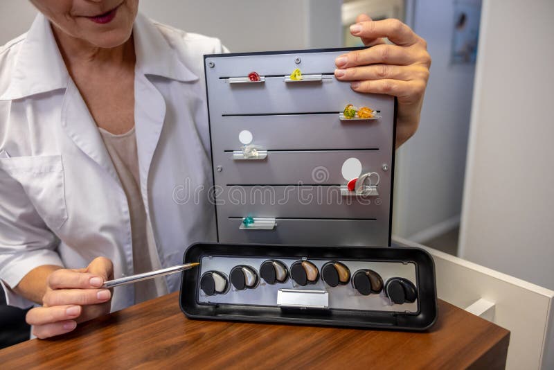 ENT Doctor Demostrating New Hearing Aid Tools Stock Photo - Image of ...