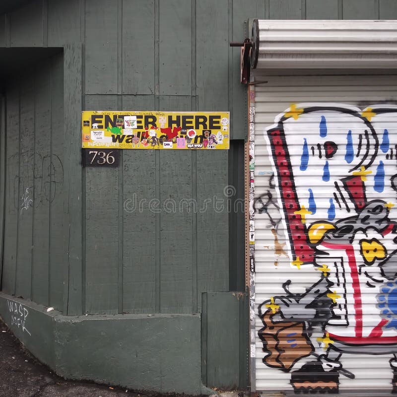 Enter Here Directional Sign on Urban Building Exterior Wall. Editorial ...