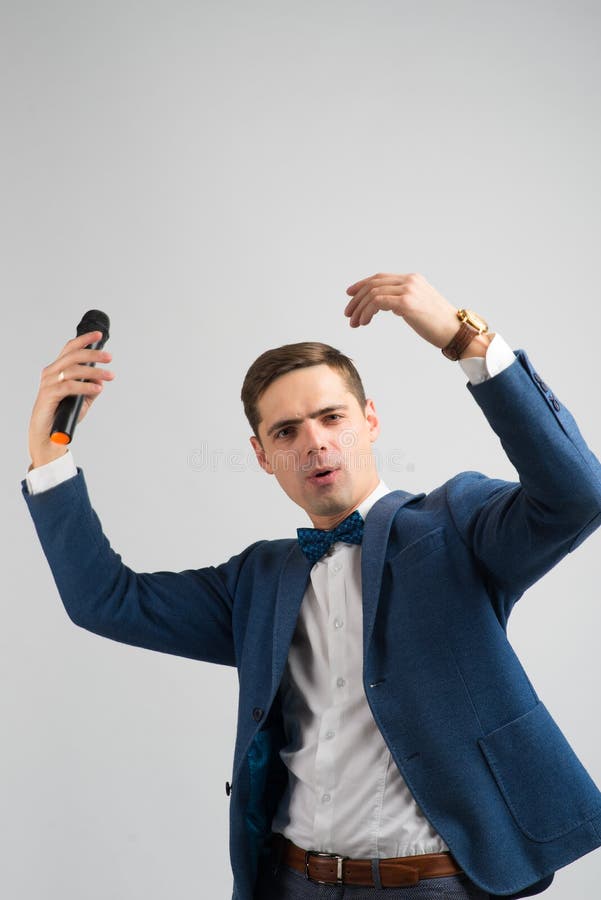 The Entertainer. Young Elegant Talking Man Holding Microphone, in ...