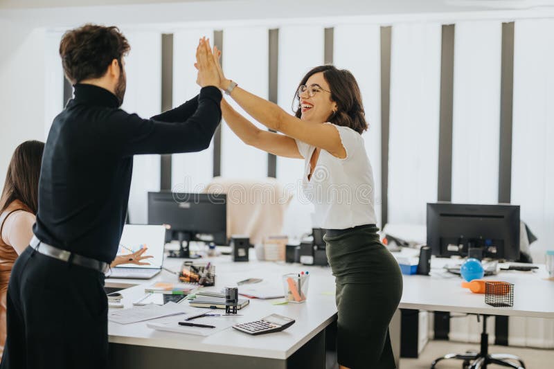 Enthusiastic Colleagues Celebrating Success with High-five in Modern ...