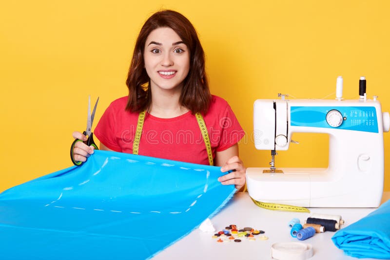 Enthusiastic Inspired Young Lady Sits at Table with Scissors Holding ...