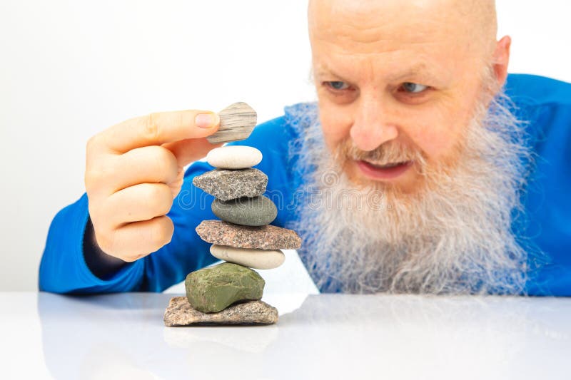 Enthusiastic Older Man Smiling Widely while Engaged in Building a Stack ...