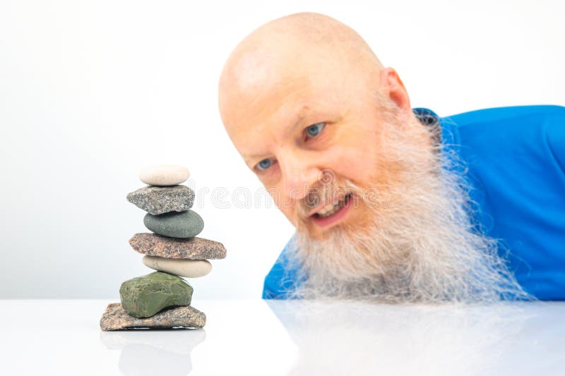 Enthusiastic Older Man Smiling Widely while Engaged in Building a Stack ...