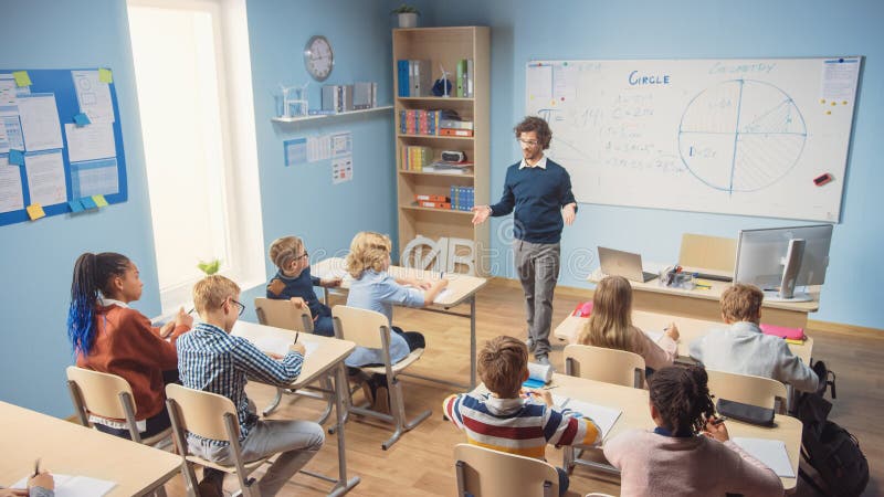 Enthusiastic Teacher Explaining Lesson To a Classroom Full of Diverse ...