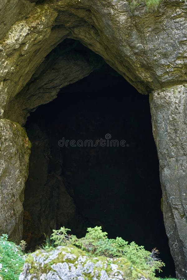 Entrance of a Cave in the Mountains Stock Photo - Image of dark, wall ...