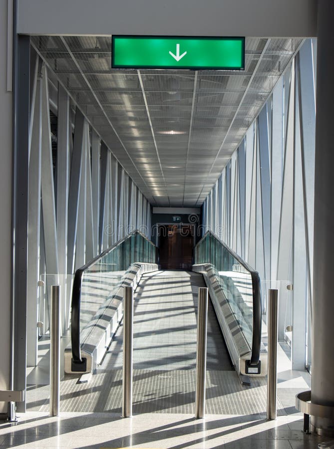 The Entrance into an Empty Corridor with a Moving Sidewalk Lit by the ...
