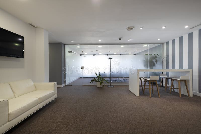 Entrance Hall of an Office with a White Leather Sofa, a High Table with ...