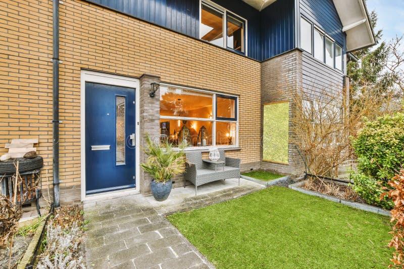 A House on the Side of a Road with Grass Stock Photo - Image of garage ...