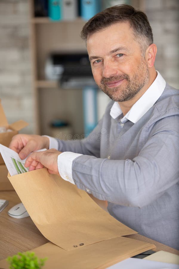 Entrepreneur Putting Papers in Envelope Stock Photo - Image of courier ...